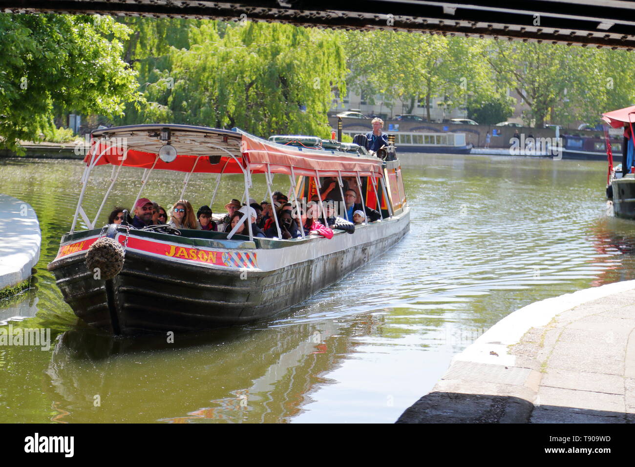 Tourists on a canal boat tour on Regents Canal in Little Venice, London ...
