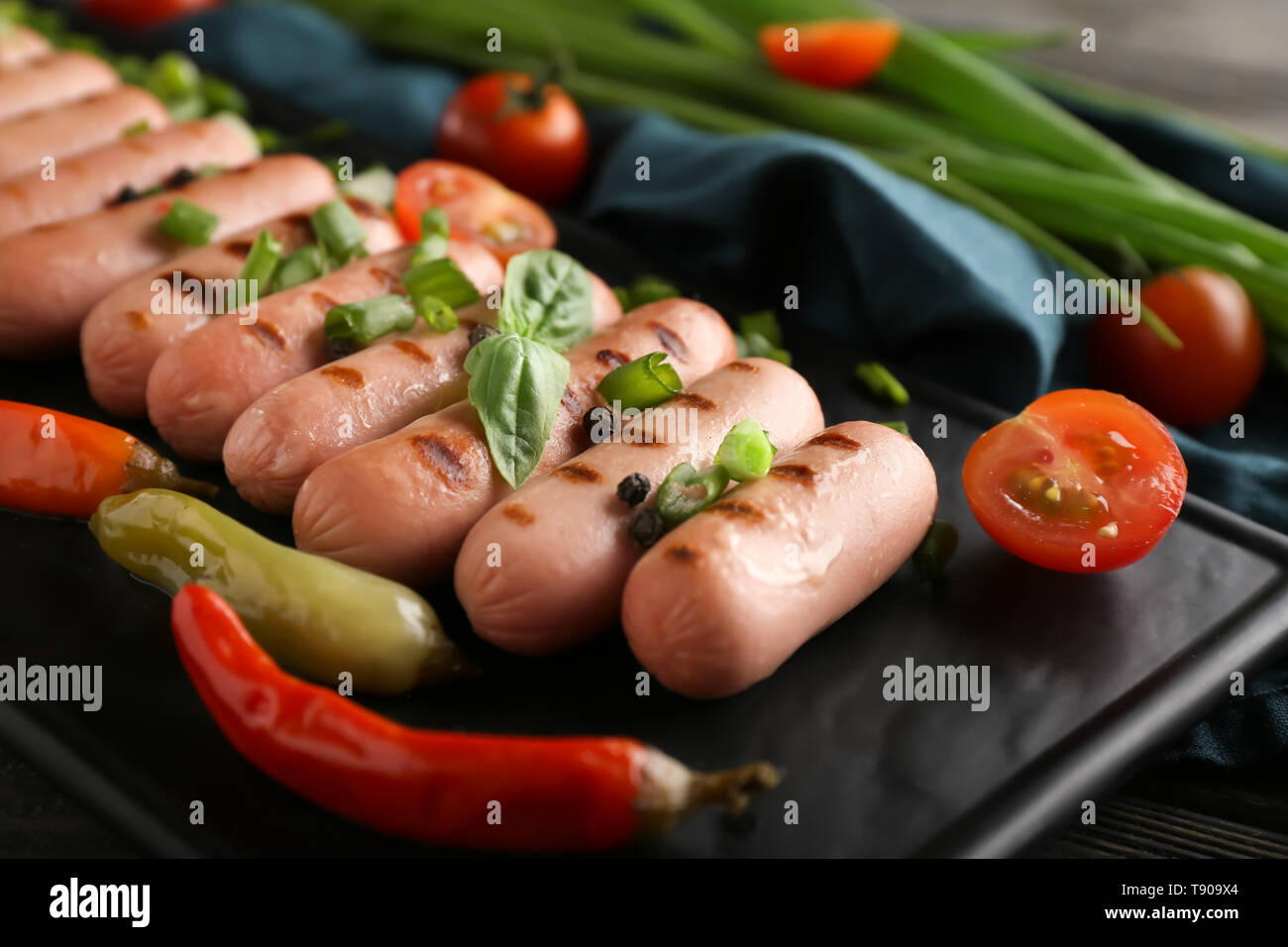 Delicious grilled sausages with vegetables on plate, closeup Stock ...
