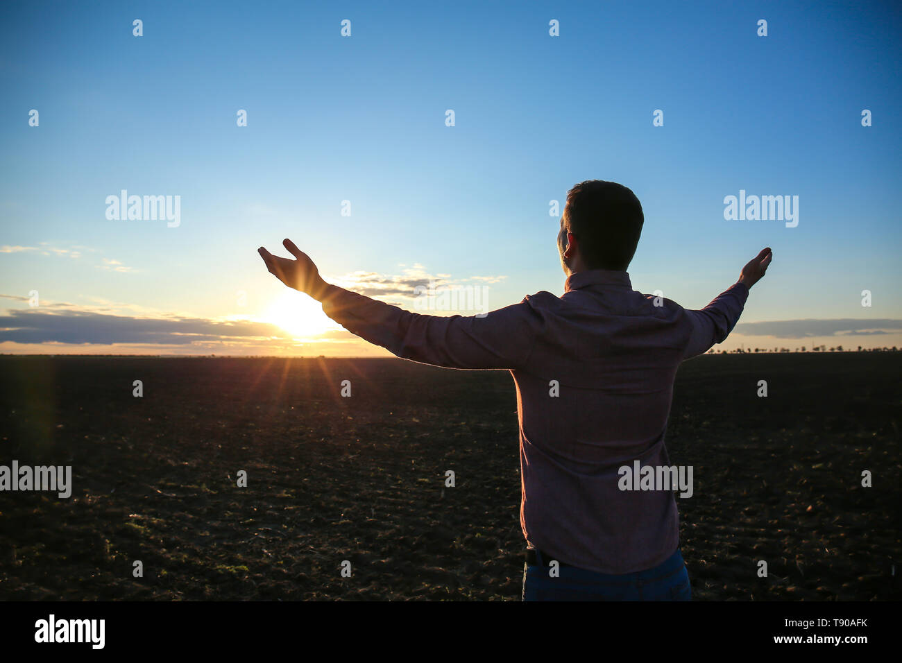Religious man praying outdoors at sunset Stock Photo - Alamy