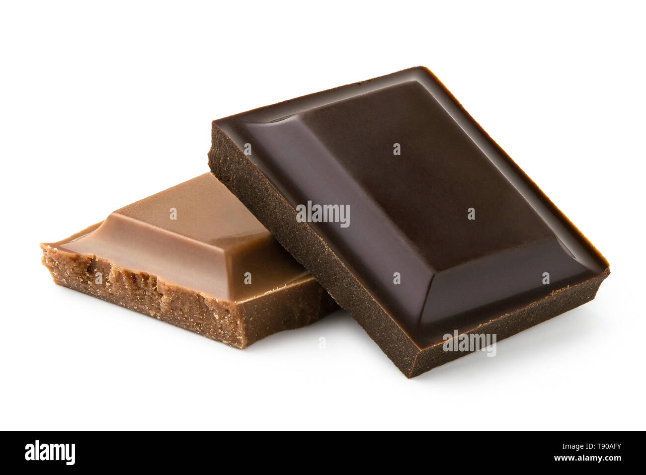 Square of dark chocolate resting on a square of milk chocolate isolated ...