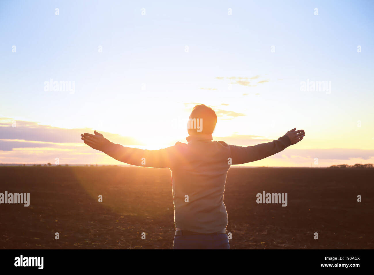 Religious man praying outdoors at sunset Stock Photo - Alamy