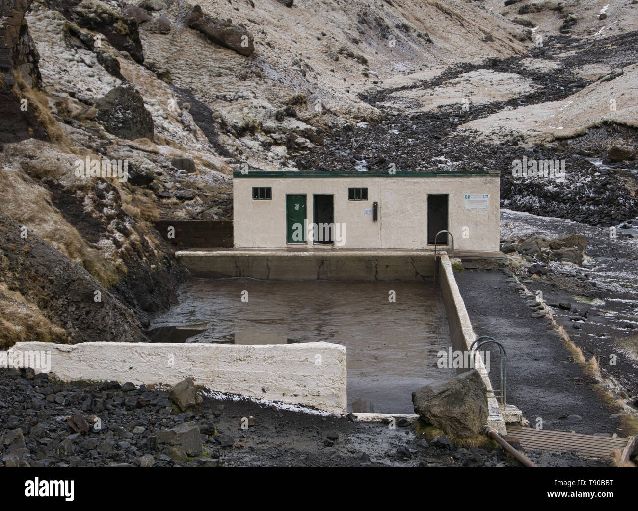 The pool of the Seljavallalaug swimming pool in Iceland without water ...