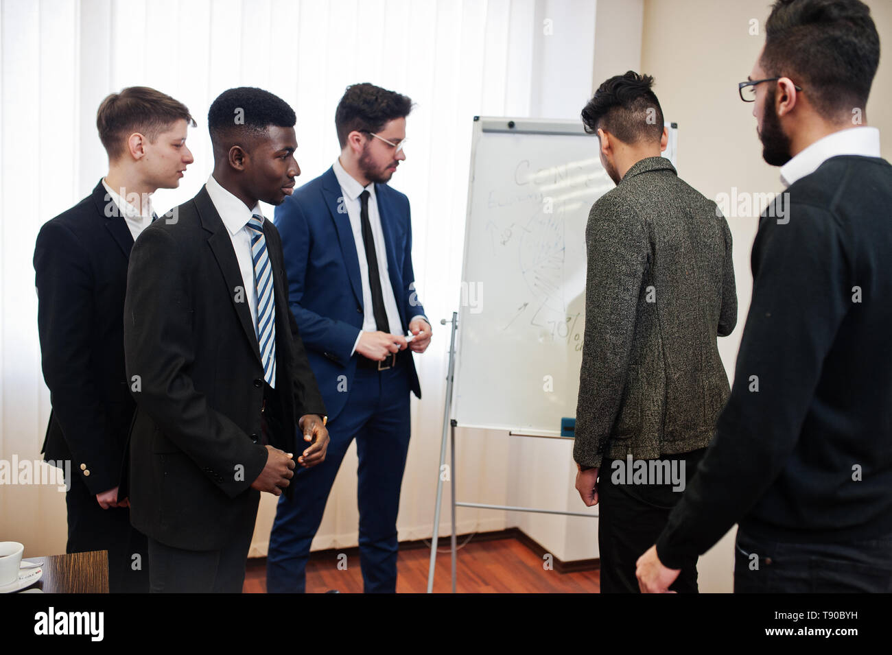 Male colleagues working in team cooperate , multiracial crew of ...