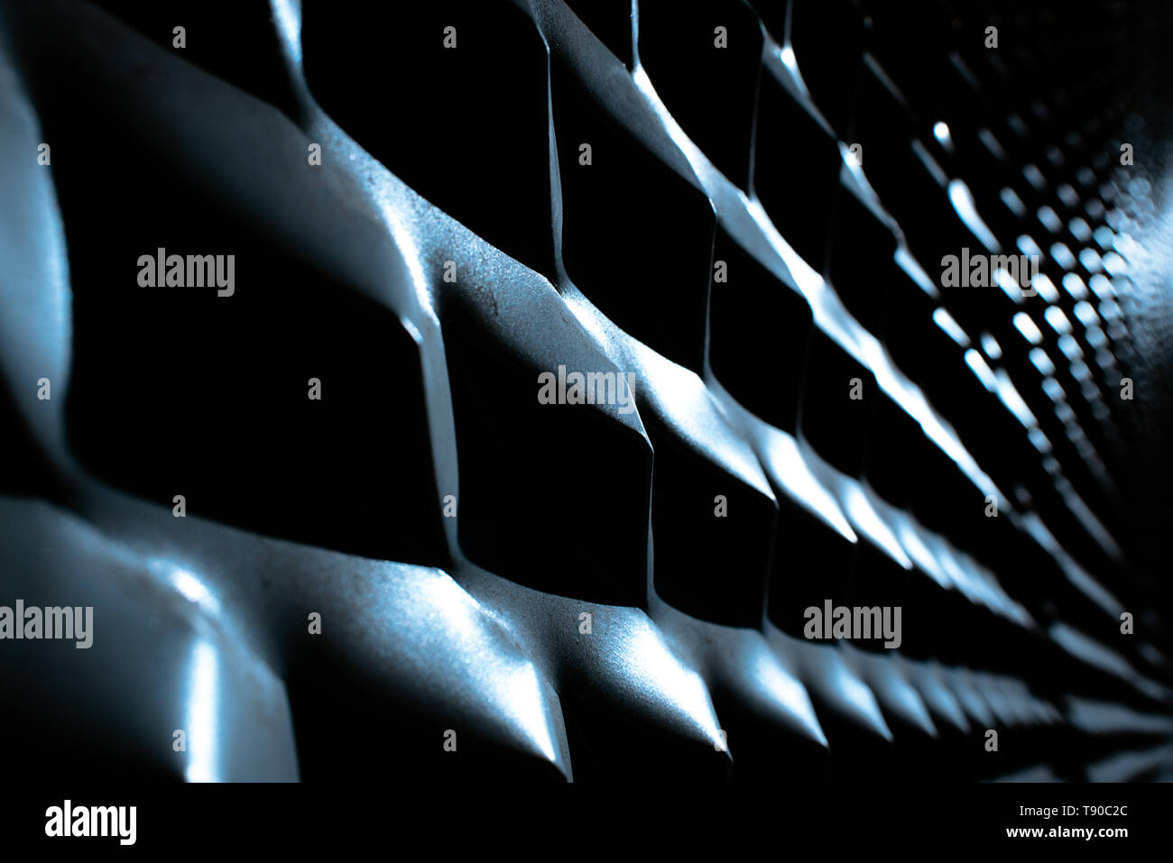 Industrial background with metallic texture illuminated with strong ...