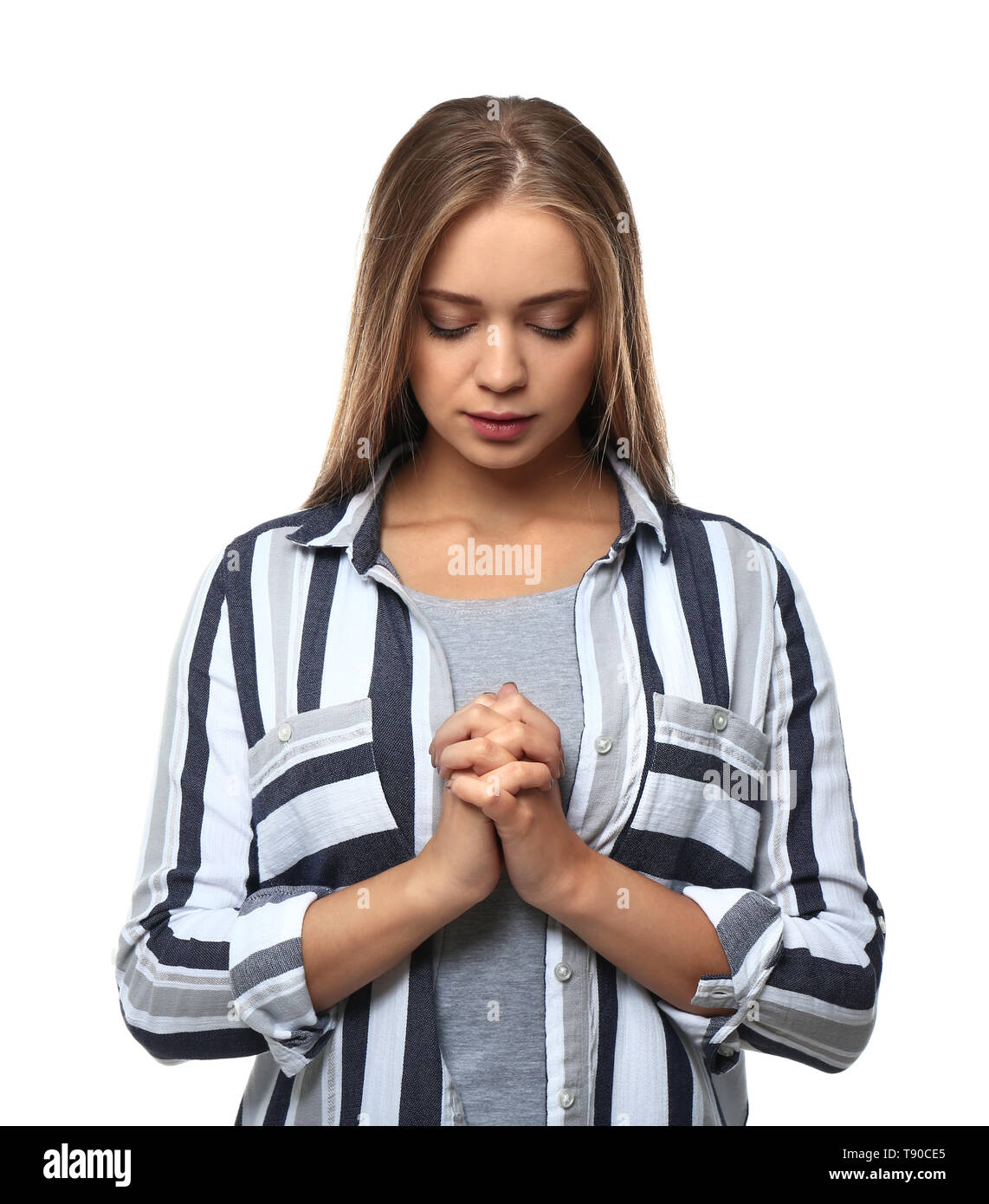 Beautiful young woman praying on white background Stock Photo - Alamy