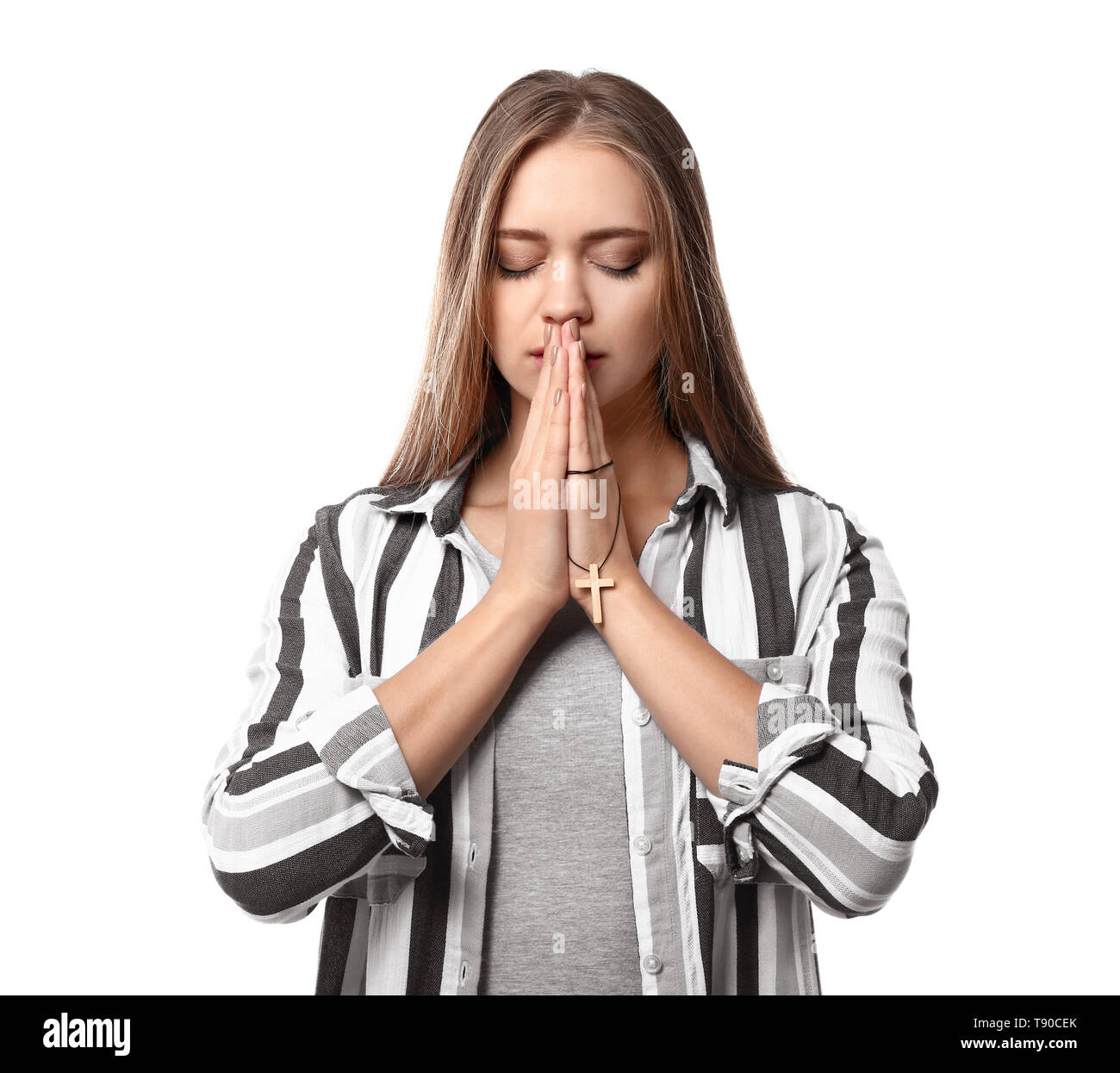 Beautiful young woman praying on white background Stock Photo - Alamy