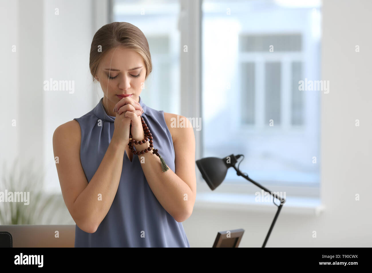 Praying office woman hi-res stock photography and images - Alamy