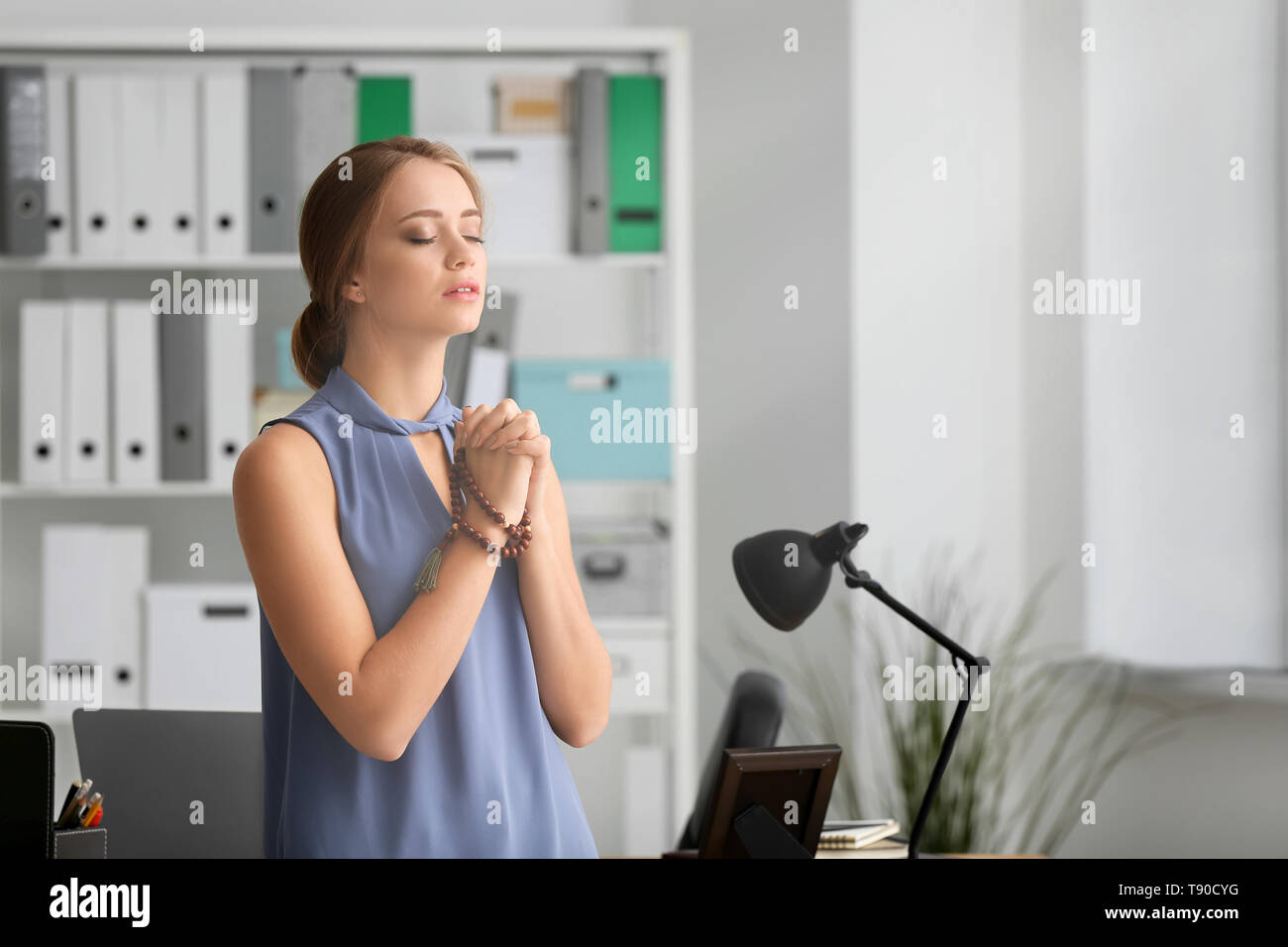 Praying office woman hi-res stock photography and images - Alamy