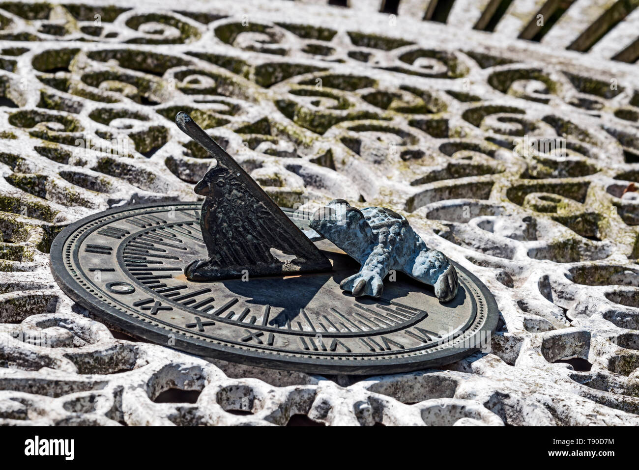 Frog and bird weathered brass sundial Stock Photo - Alamy