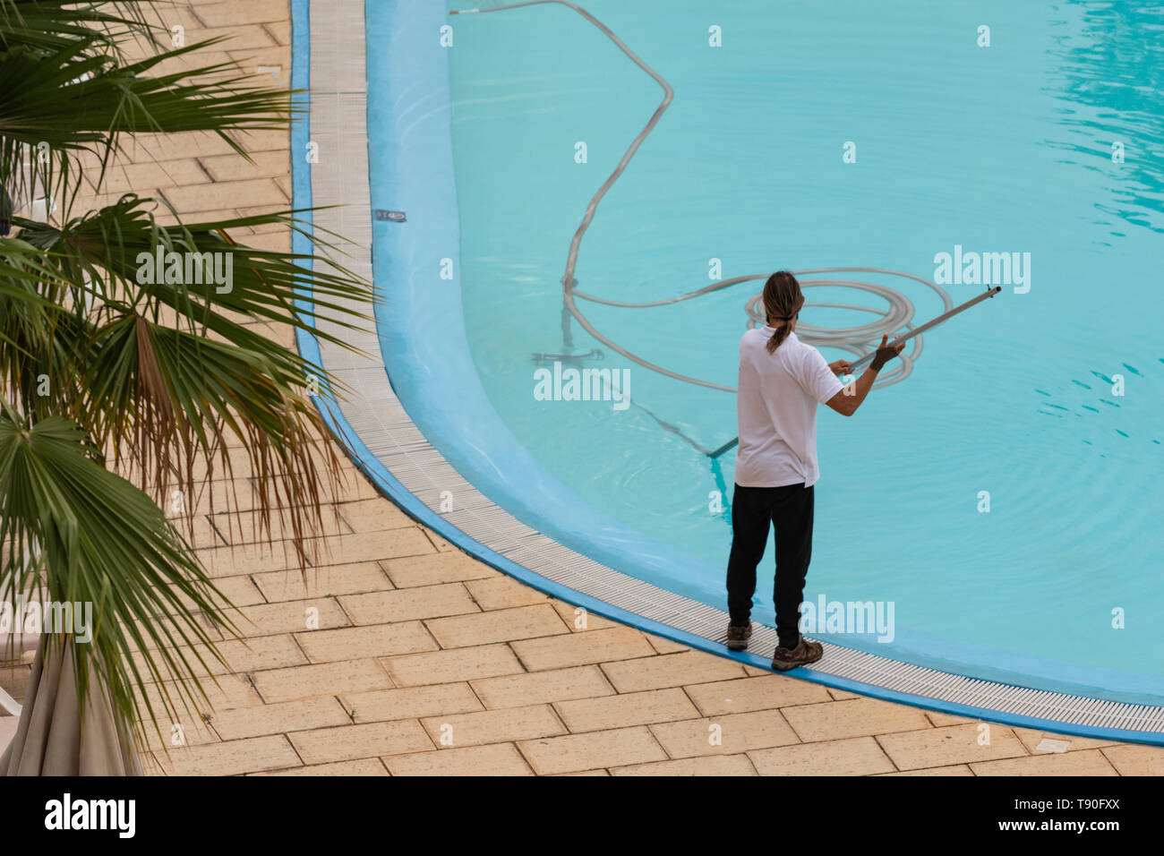 Pool hotel man cleaning hi-res stock photography and images - Alamy