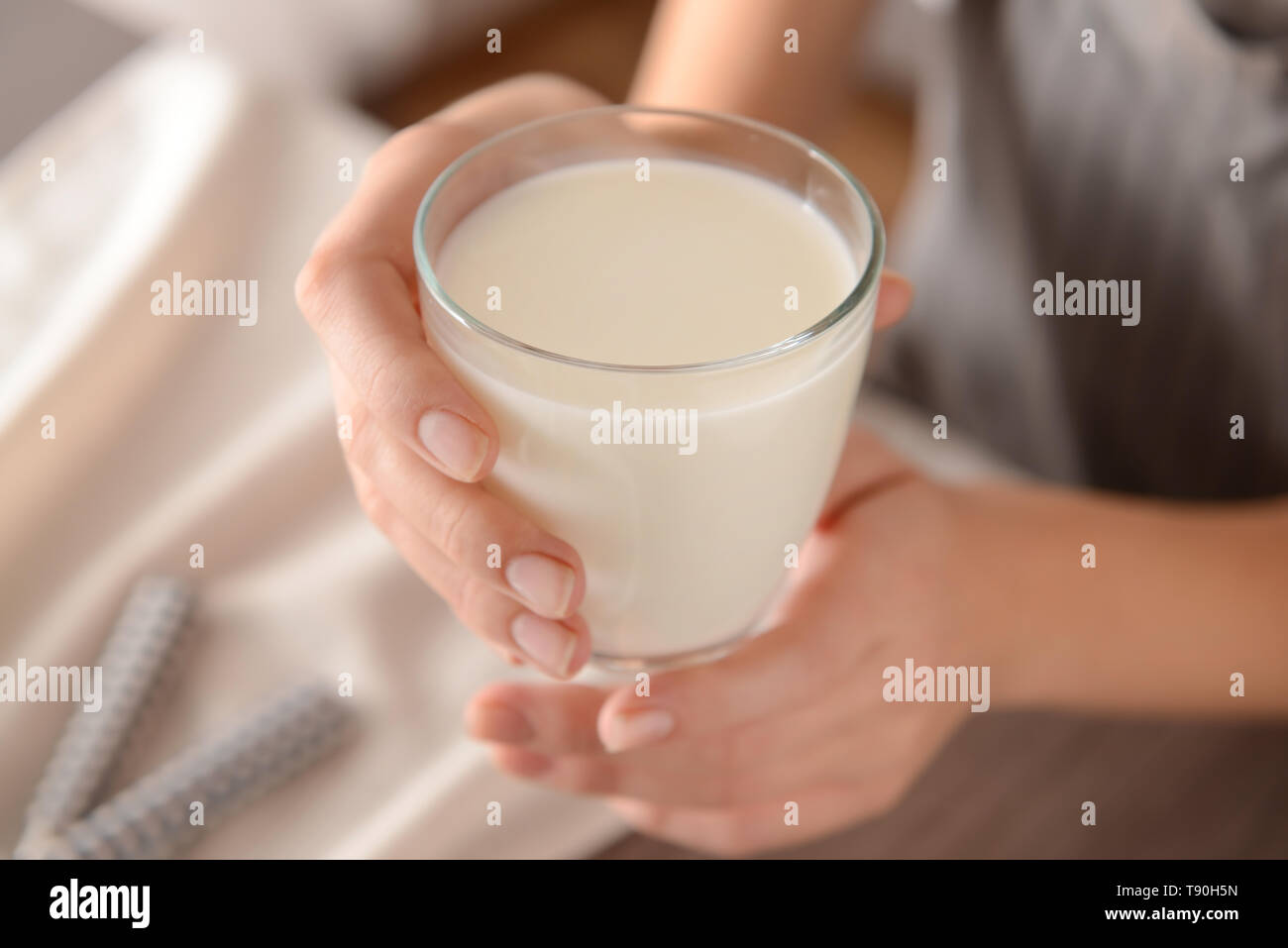 Female hands holding glass of delicious milk, closeup Stock Photo - Alamy