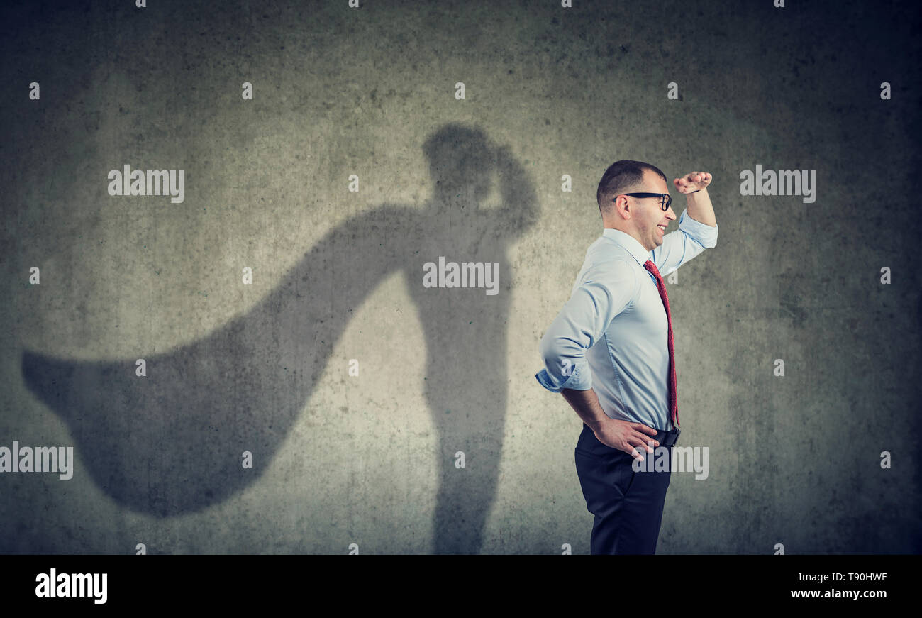 Side view of a business man imagining to be a super hero looking ...