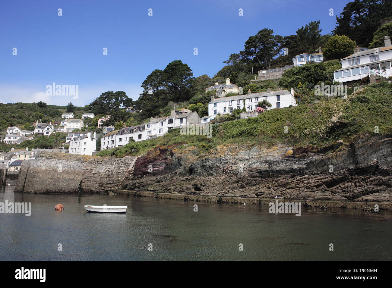 The outer harbour of Polperro at low tide and the Warren Stock Photo ...