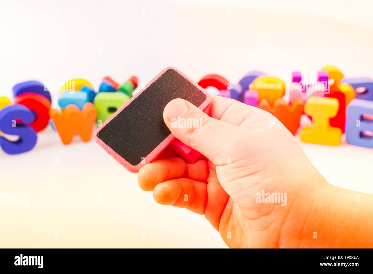 Hand holding a mini size notice board made of wood Stock Photo - Alamy