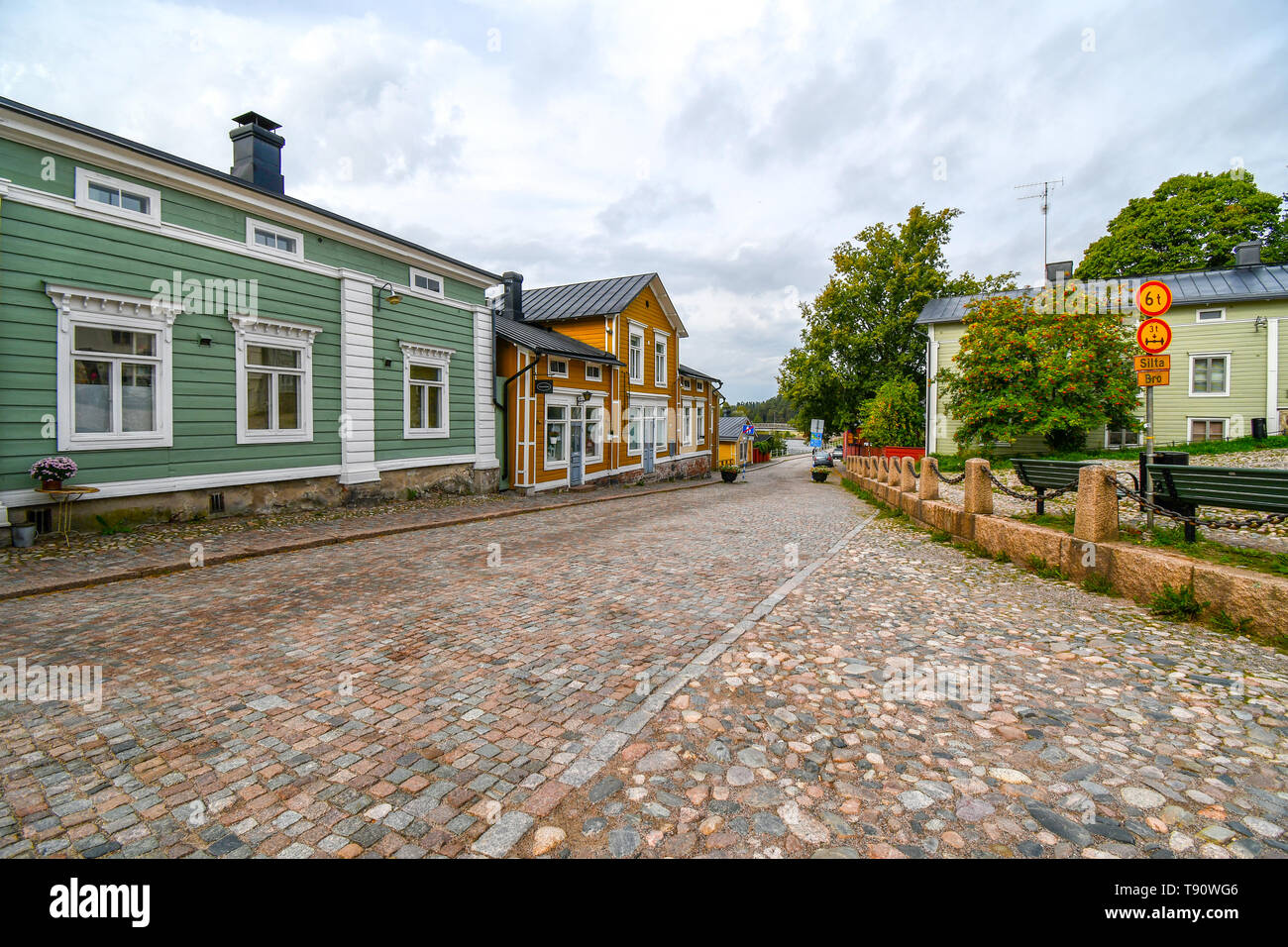 Colorful buildings line the cobblestone streets at the entrance to the ...