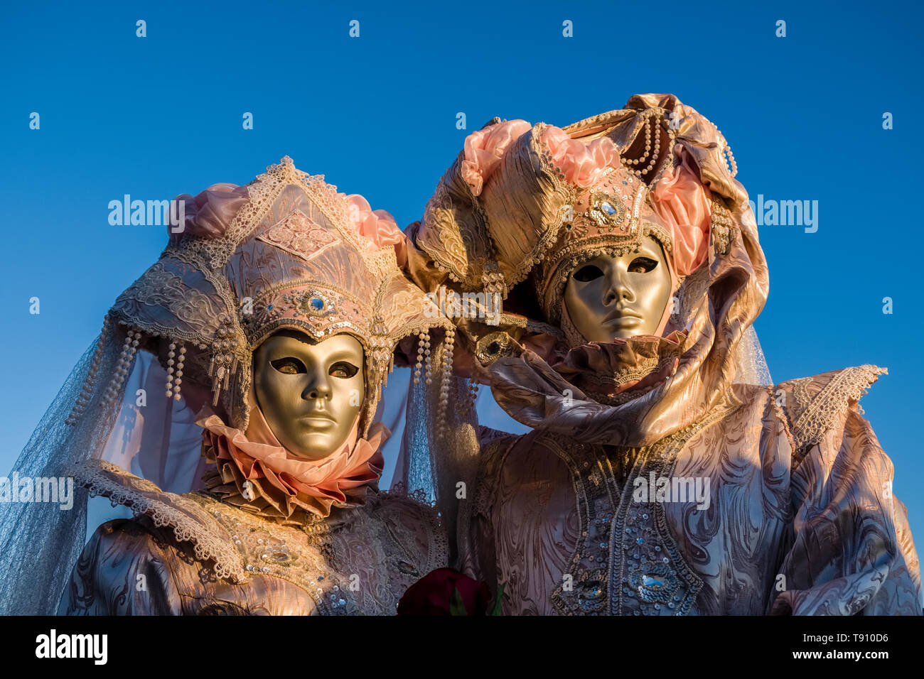 Portraits of two masked people in beautiful creative costumes ...