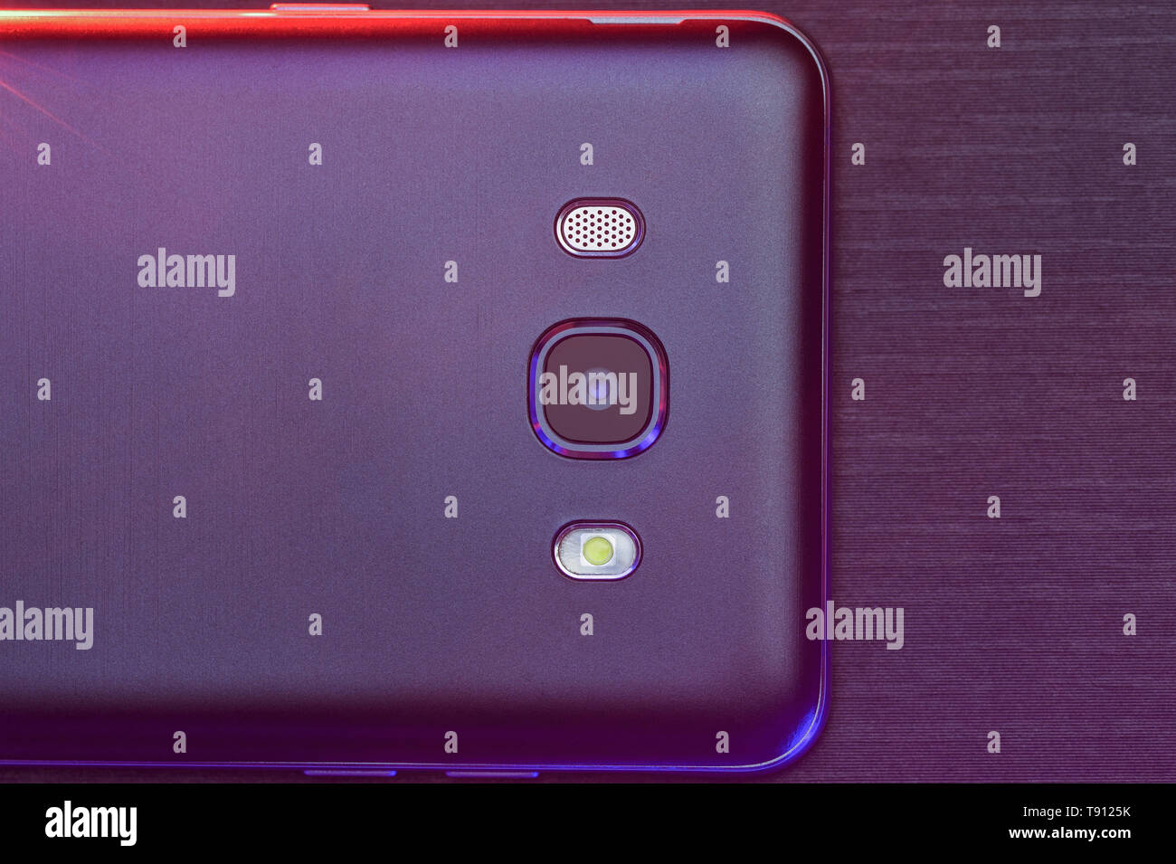 Close-up of a black smartphone is the camera to the top on a black ...