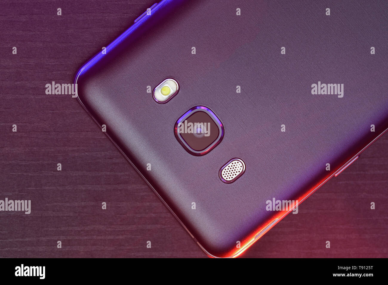 Close-up of a cell phone in black lies upside down upside down camera ...