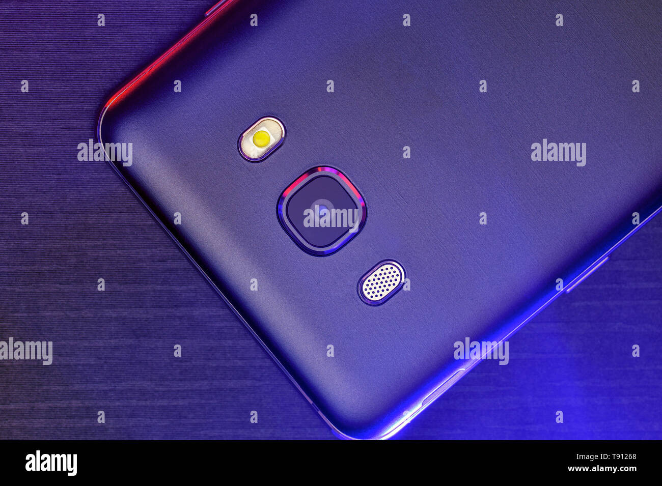 A fragment of the cell phone case in black with red and blue backlight ...