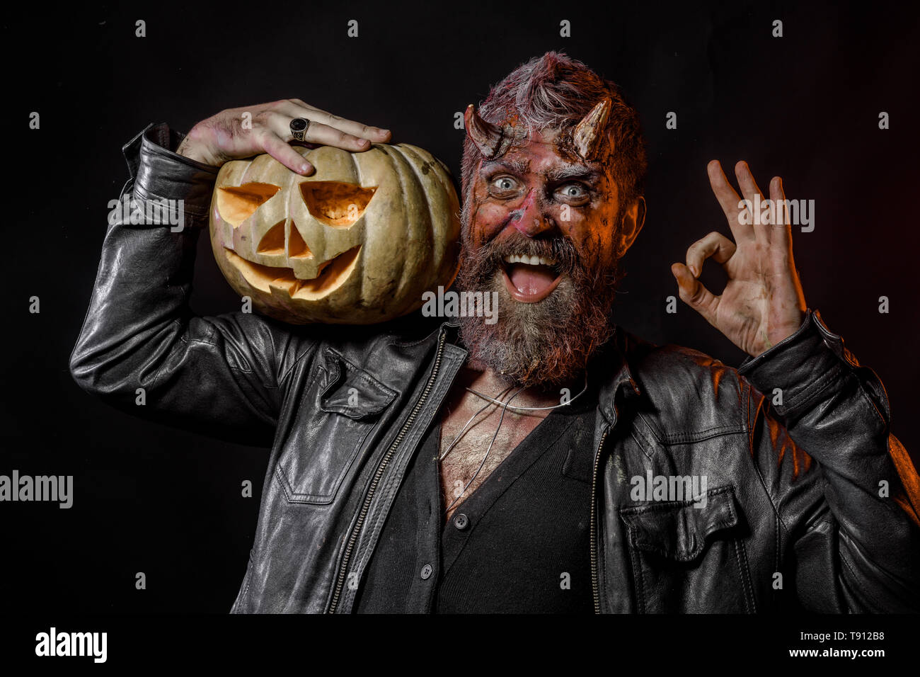 Halloween holidays celebration. Hipster hold candlestick with candles ...