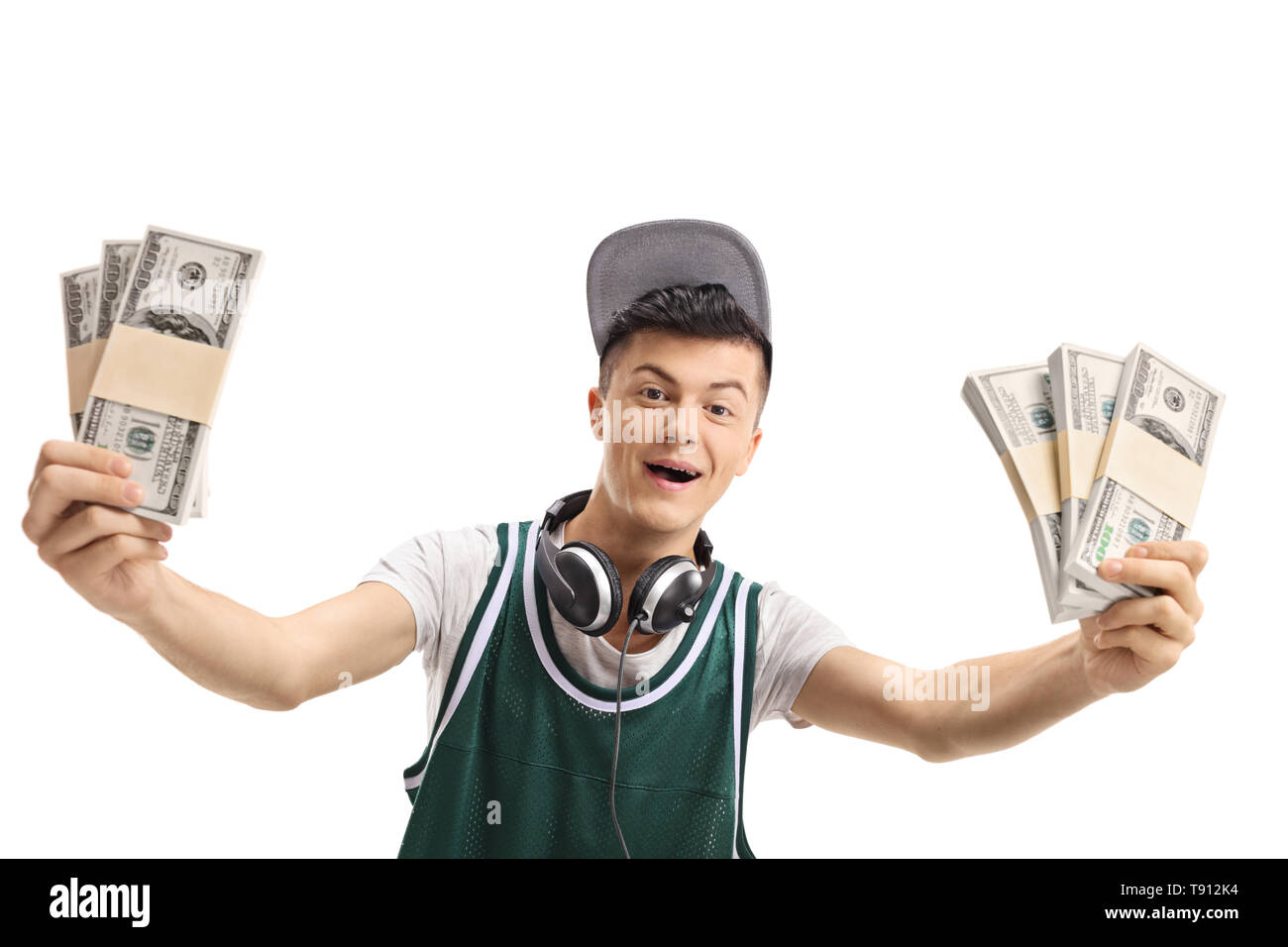Cheerful young guy with bundles of money isolated on white background ...