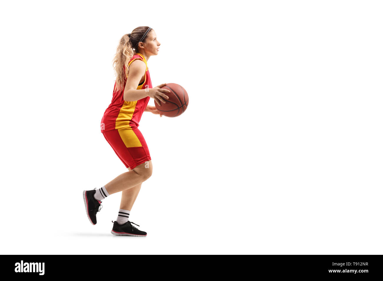 Full length shot of a female basketball player running with a ball ...