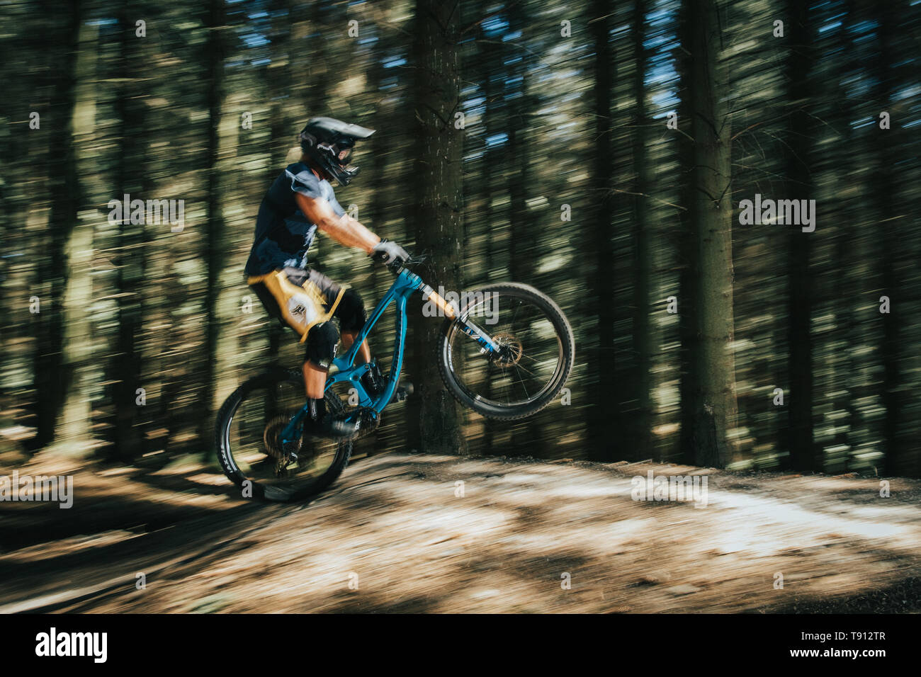Mountain bike riders jumping across table tops at the BikePark Wales ...