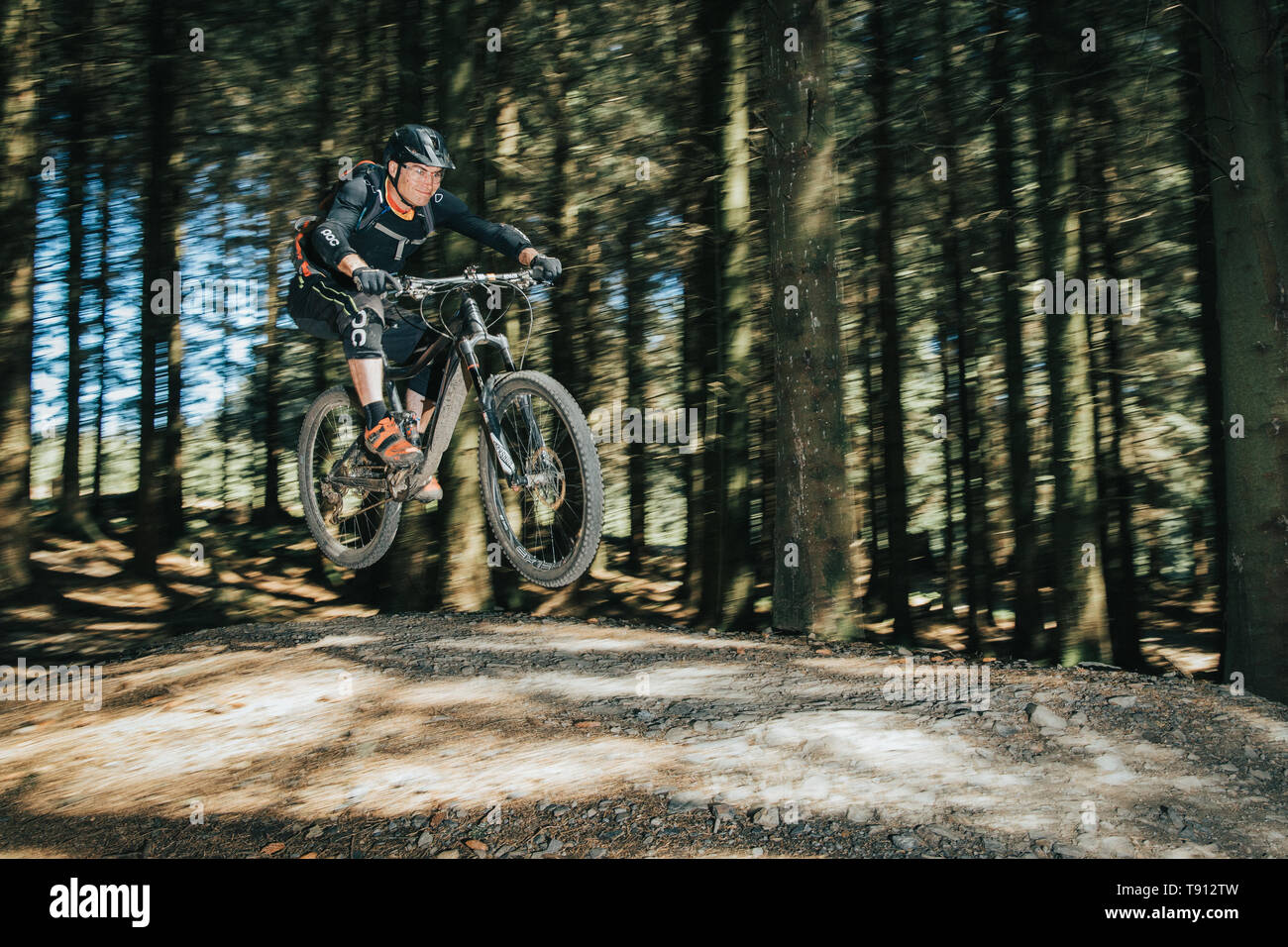 Mountain bike riders jumping across table tops at the BikePark Wales ...