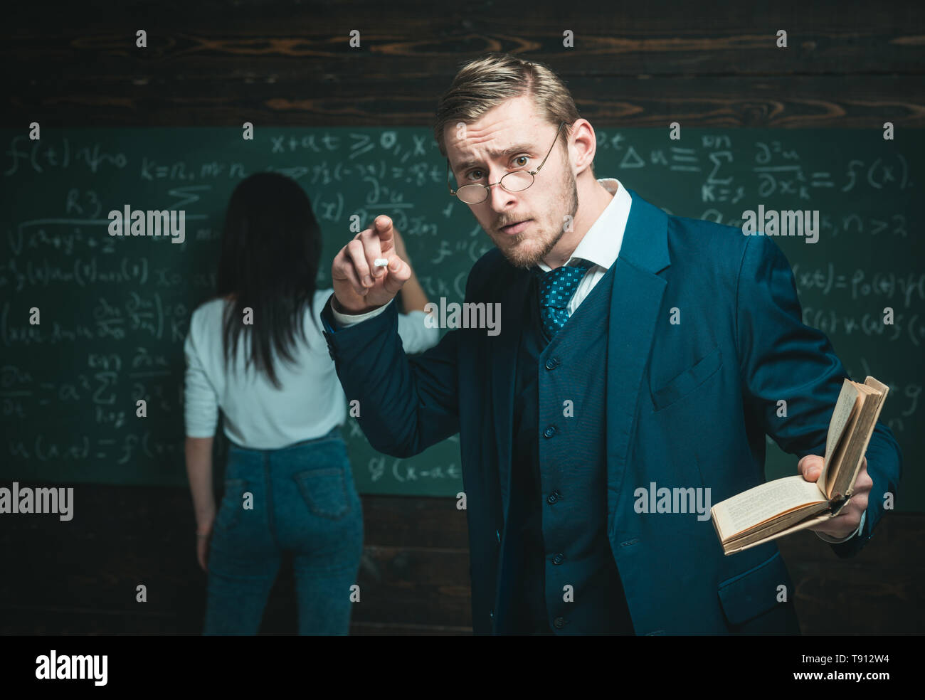 Agitated young professor passionately explaining mathematic formula ...