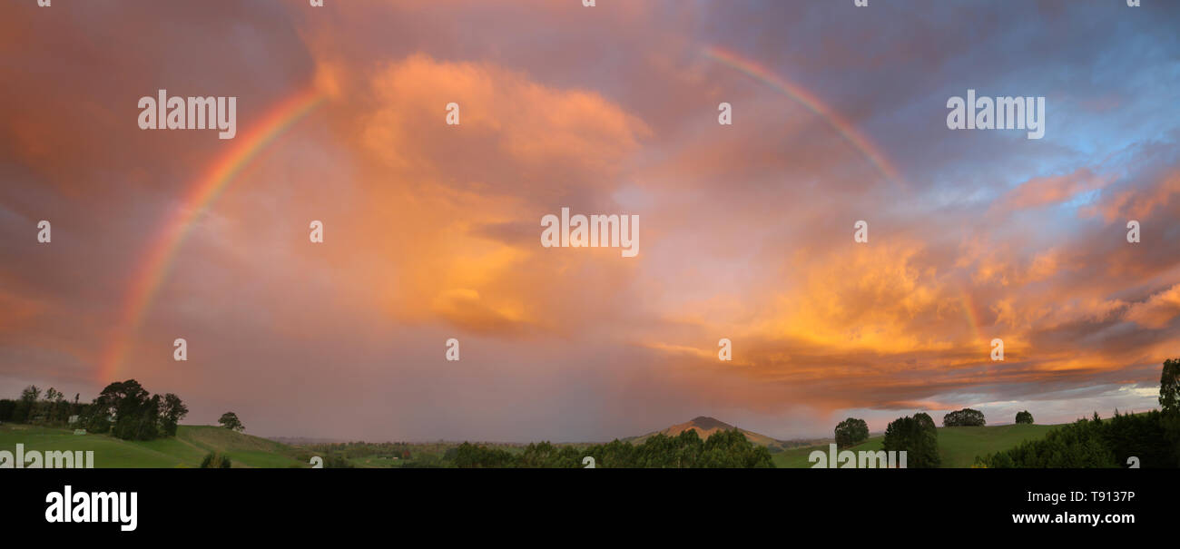 Rainbow in sunset sky over New Zealand landscape Stock Photo - Alamy