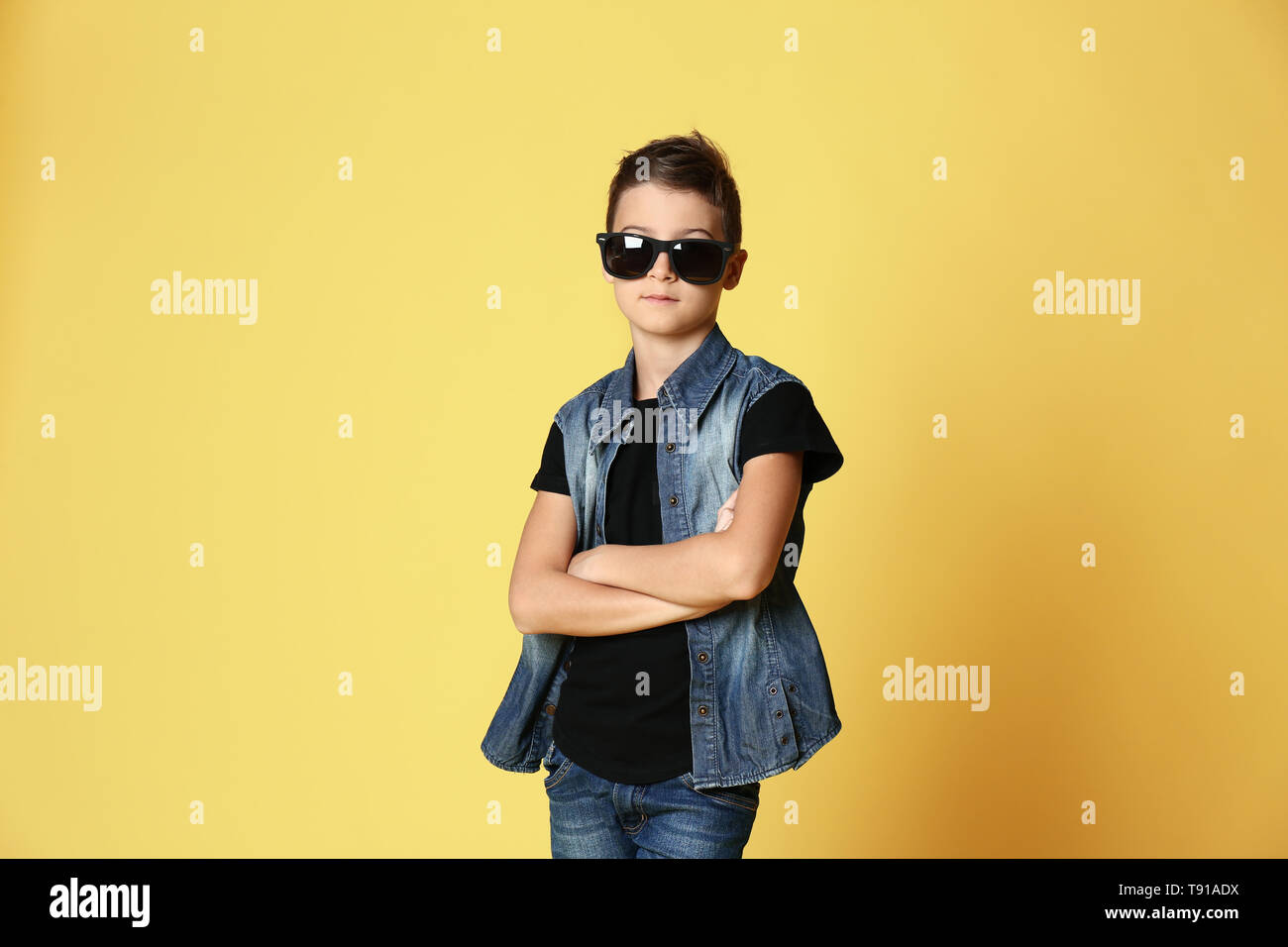 Cute boy in fashionable clothes on color background Stock Photo - Alamy