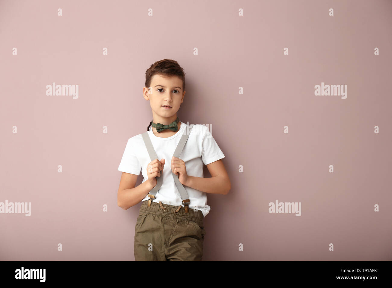 Cute boy in fashionable clothes on color background Stock Photo - Alamy