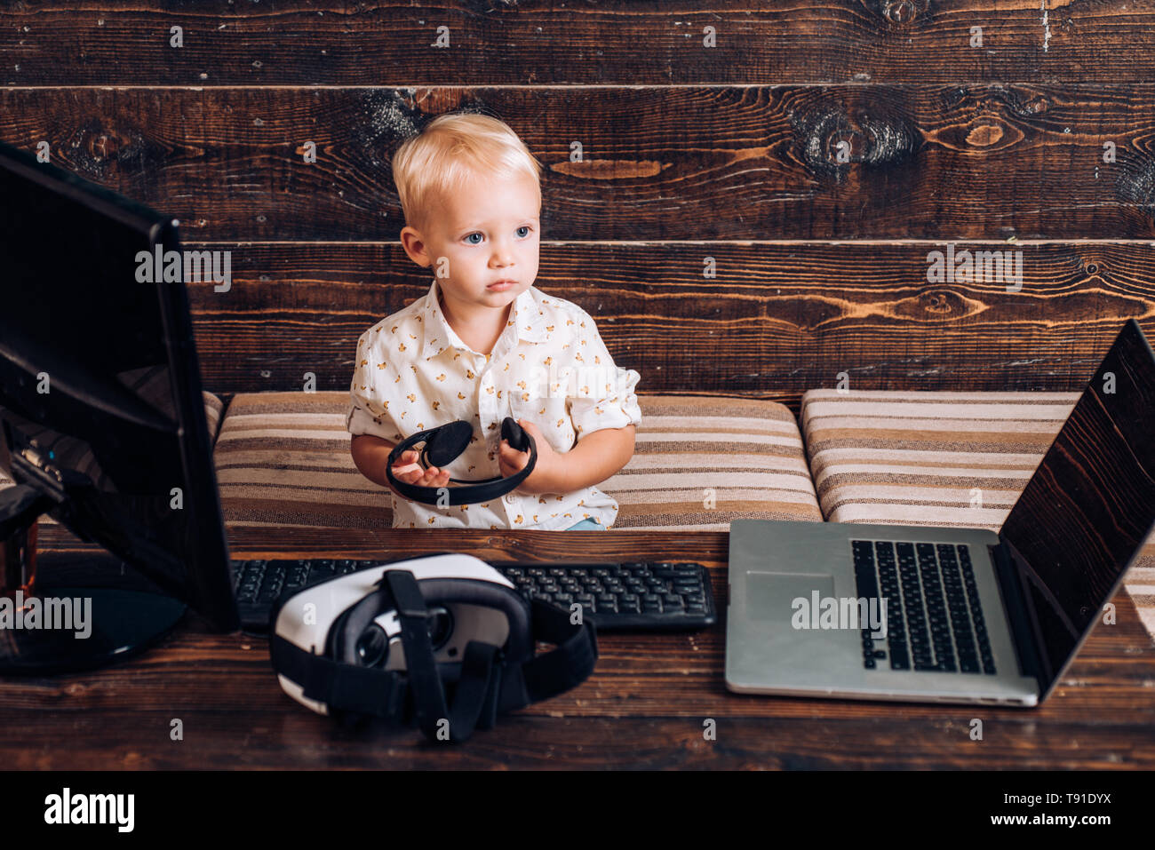 Toddler use laptop and pc computer. Little boy sit at computer work ...