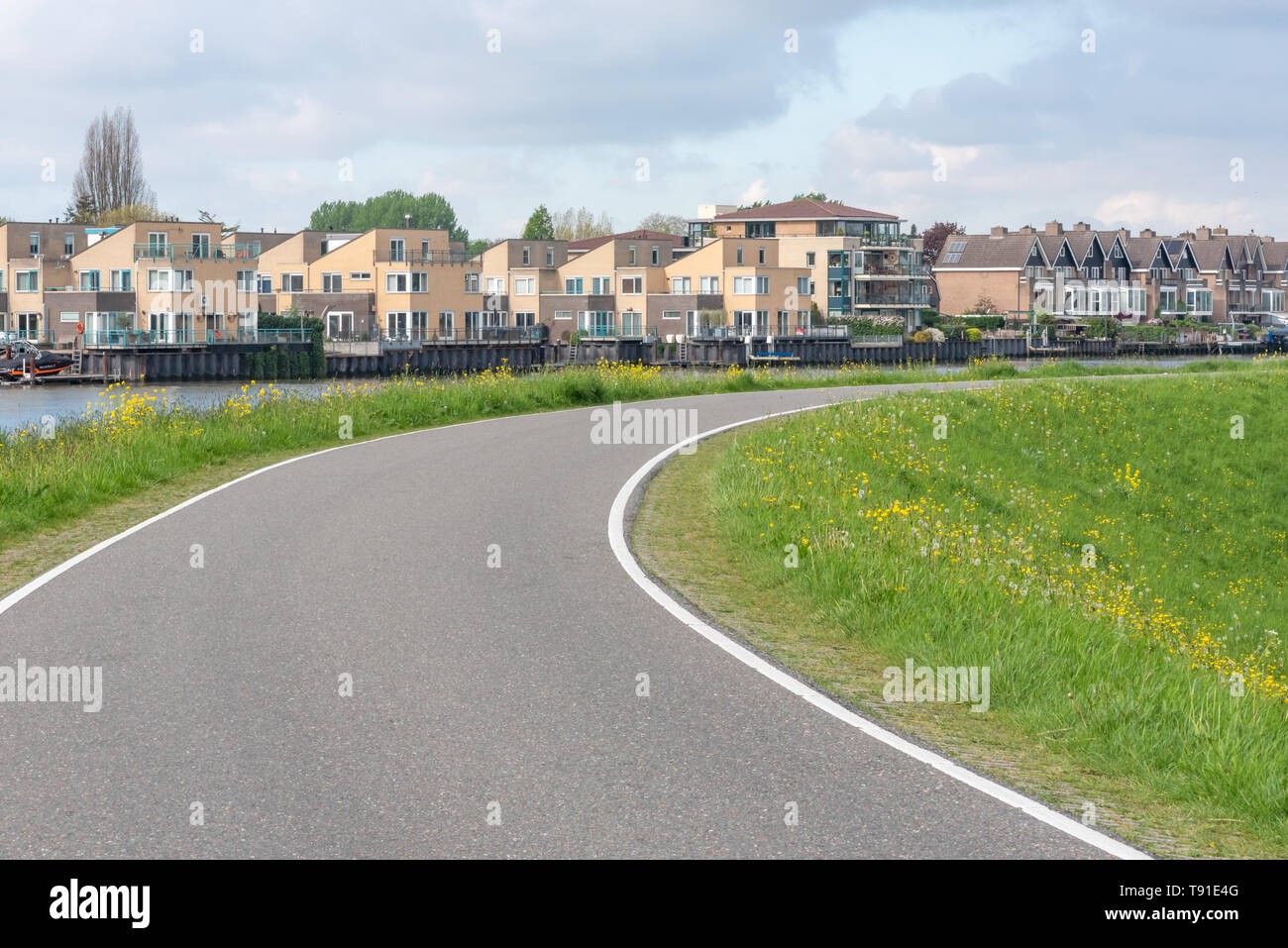 Empty curved road on a dam in the dutch countryside, Capelle Aan Den ...