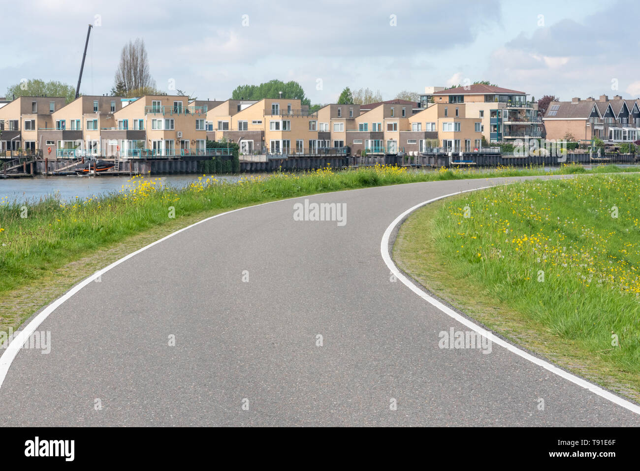 Empty curved road on a dam in the dutch countryside, Capelle Aan Den ...