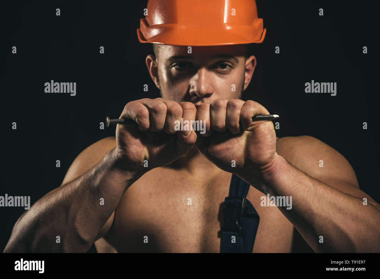 Whatever it takes. Muscular man bend nail. Strong man with muscular ...