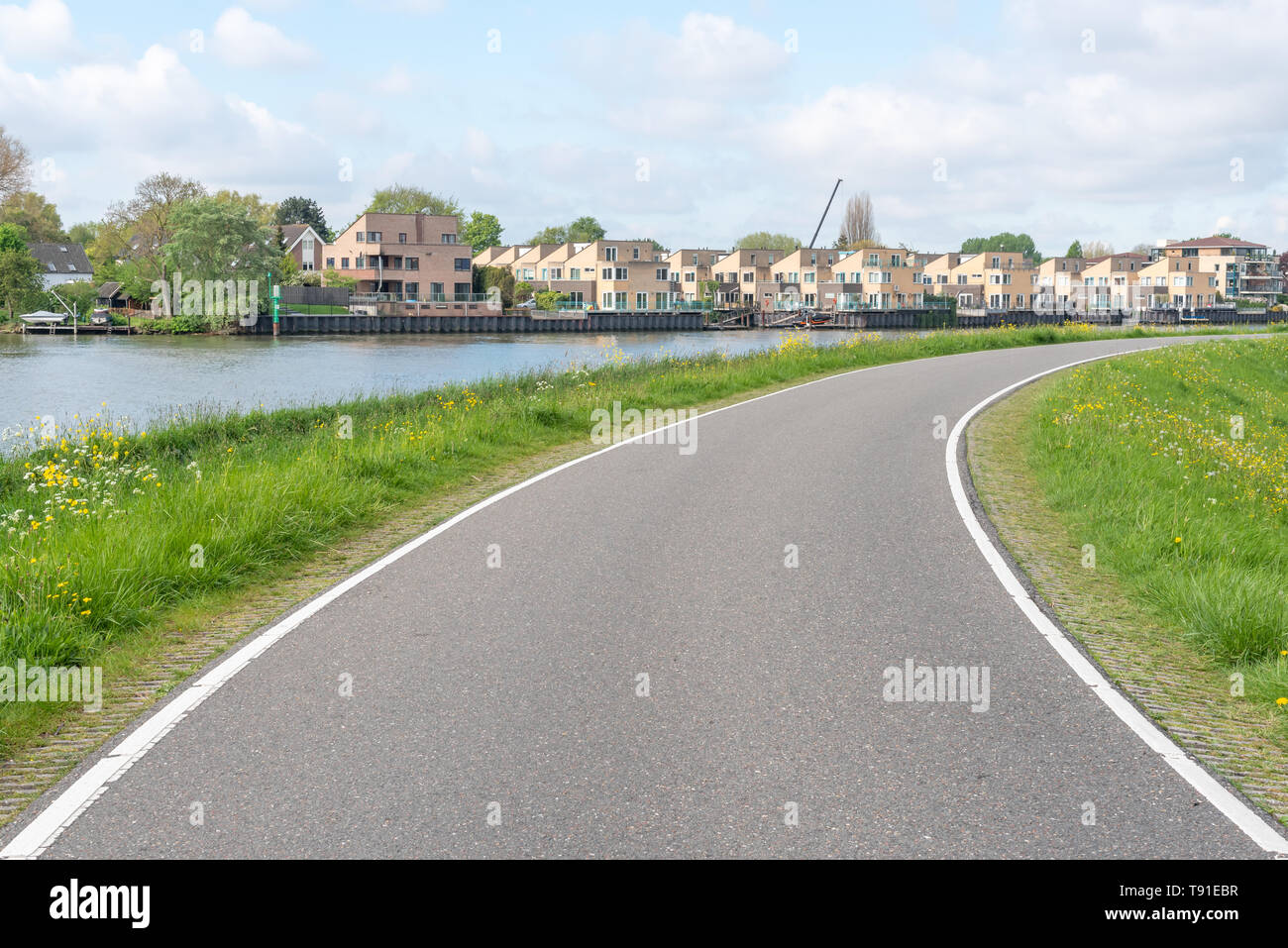 Empty curved road on a dam in the dutch countryside, Capelle Aan Den ...