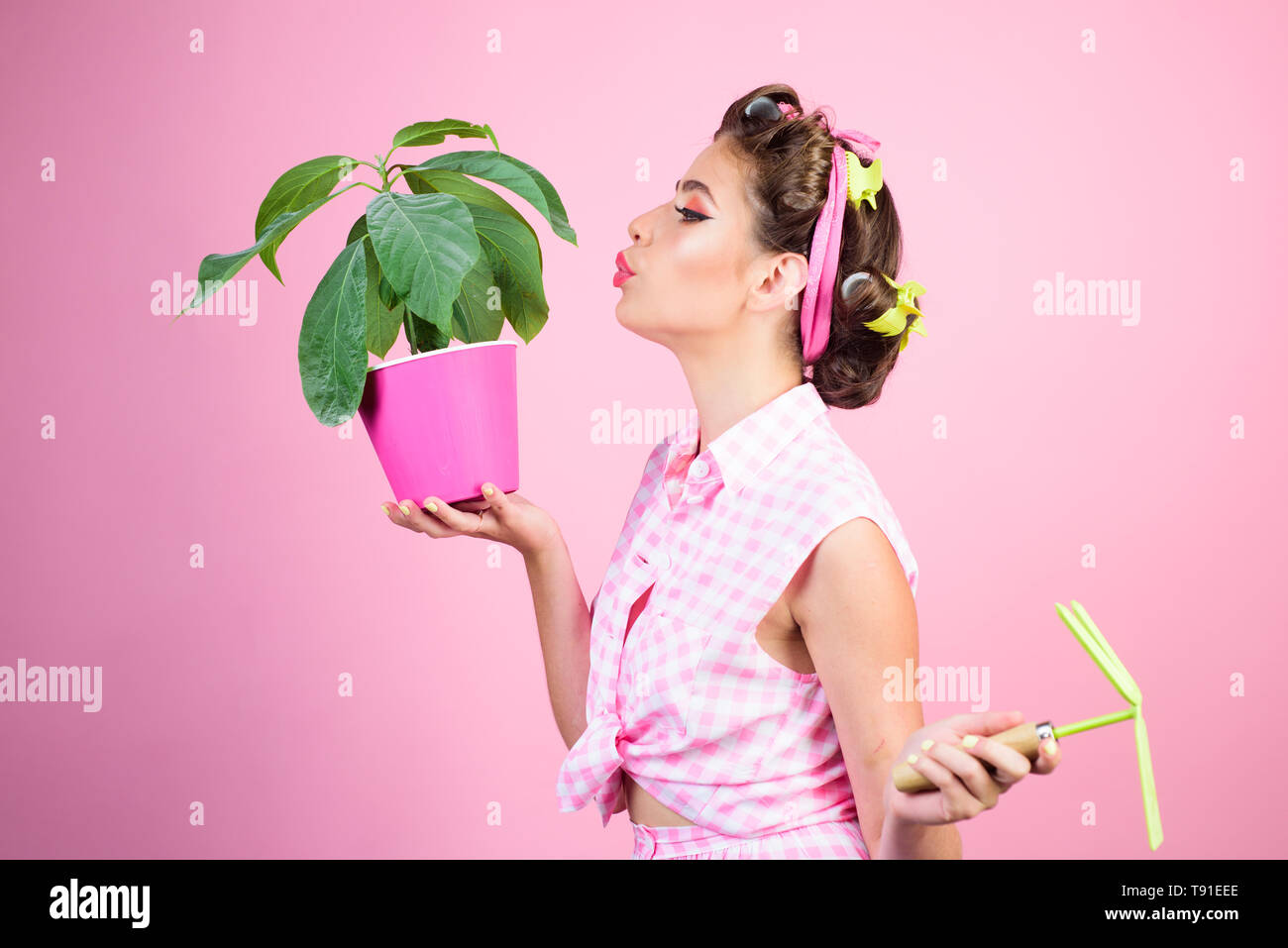 retro woman growing plants. Garden. pinup girl with fashion hair ...