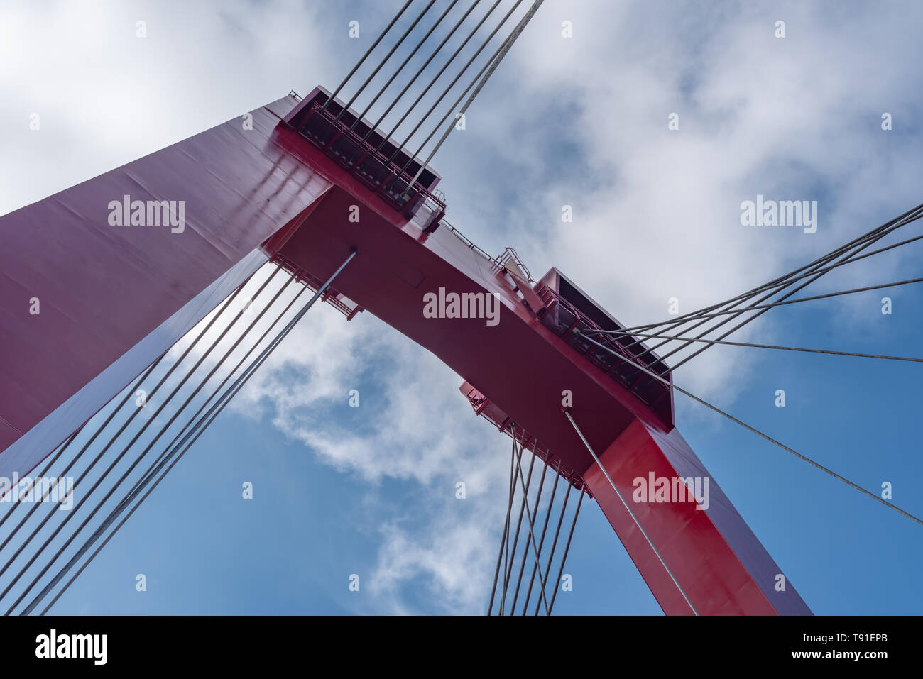Willemsbrug bridge red cable bridge against blue sky and white clouds ...