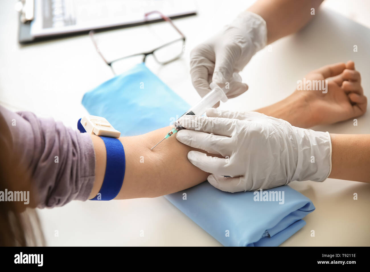 Doctor taking blood sample from vein in hospital Stock Photo - Alamy