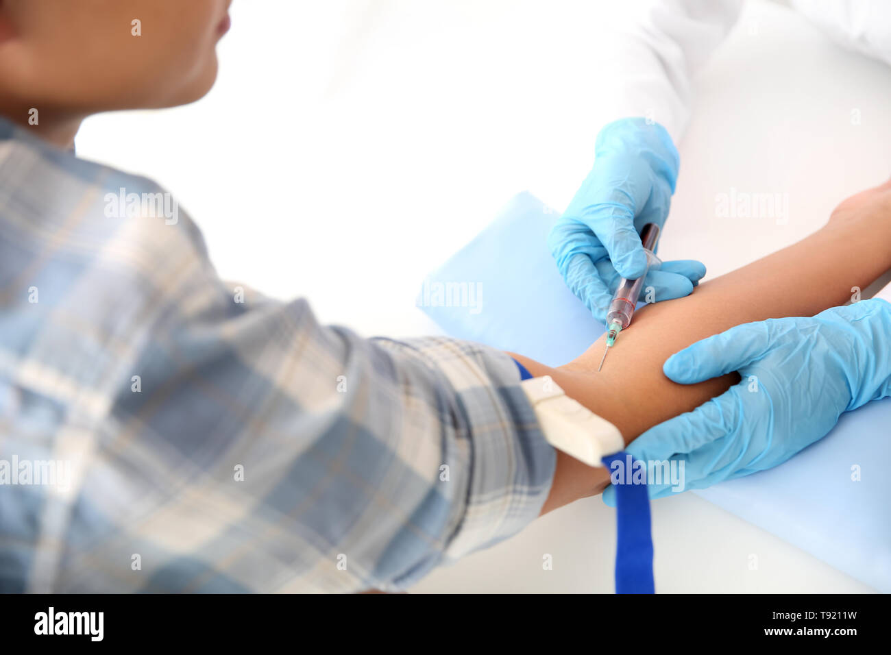 Doctor taking blood sample from vein in hospital Stock Photo - Alamy