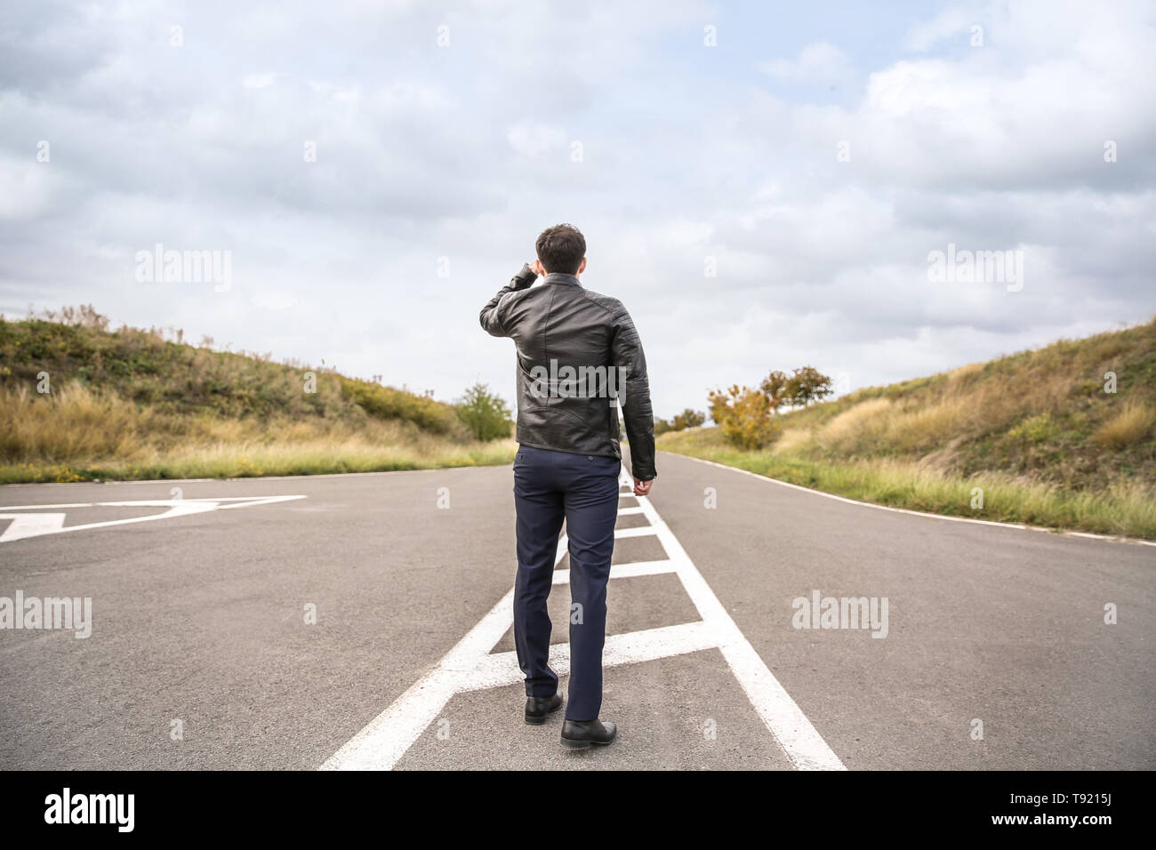 Man standing on road hi-res stock photography and images - Alamy