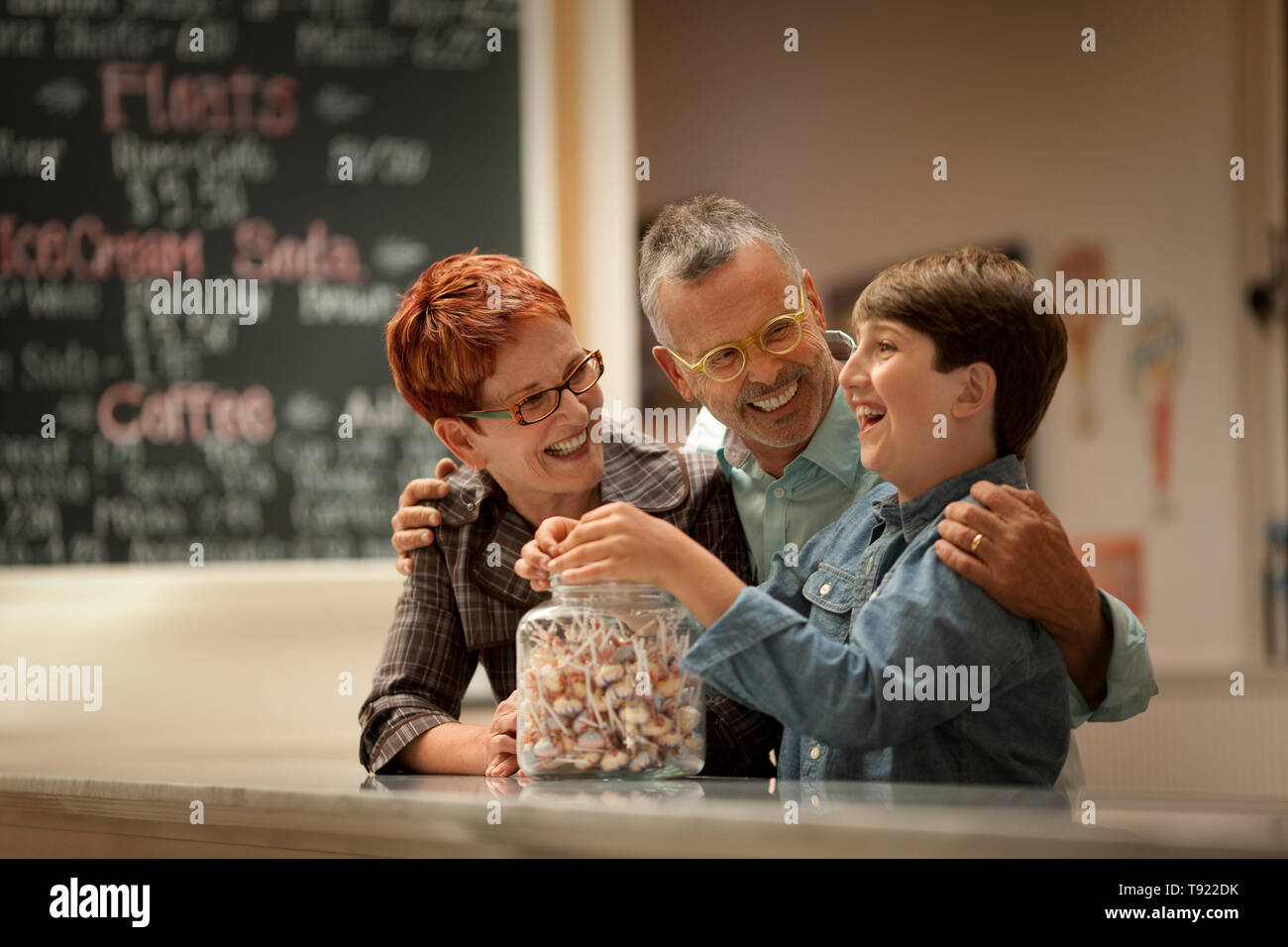 Smiling family bonding at a candy store Stock Photo - Alamy