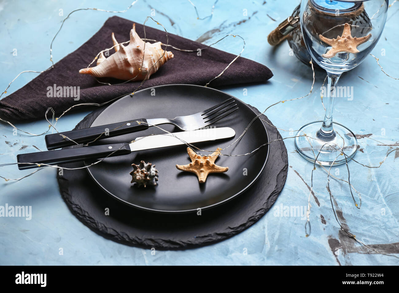 Beautiful table setting with sea shells on light background Stock Photo ...