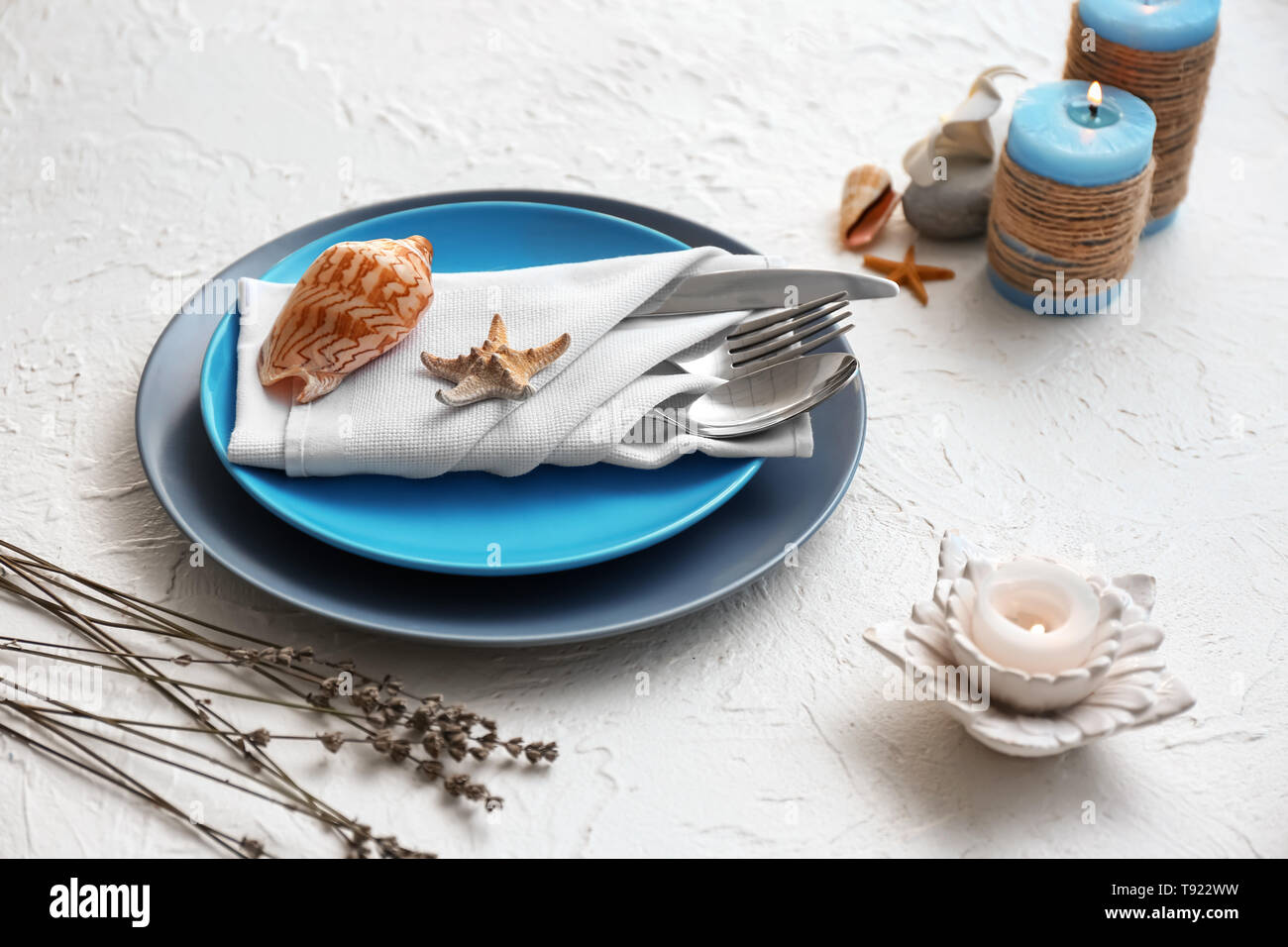 Beautiful table setting with sea shells on light background Stock Photo ...