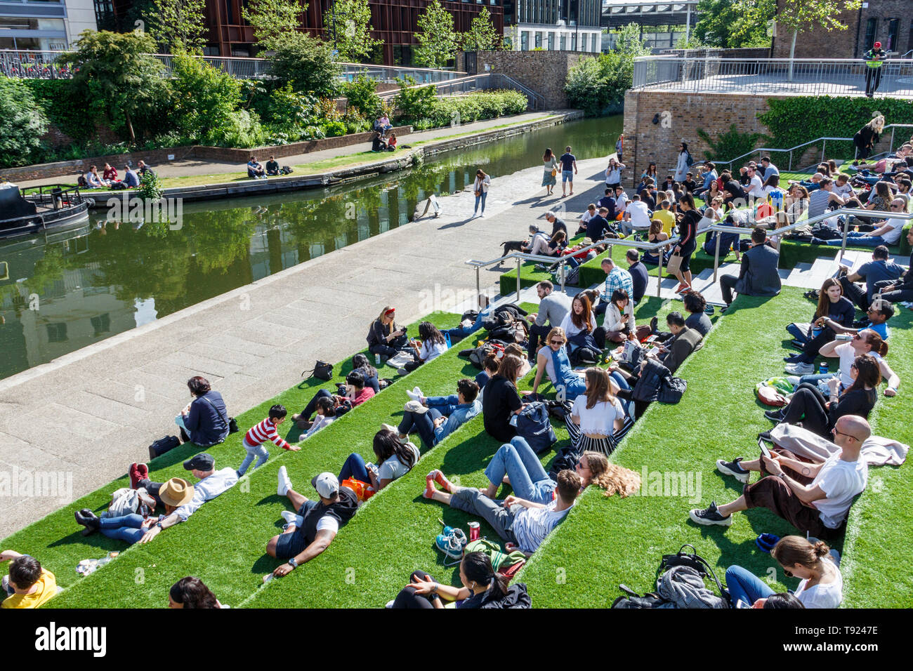 Londoners basking in spring sunshine on the steps of Granary Square by ...