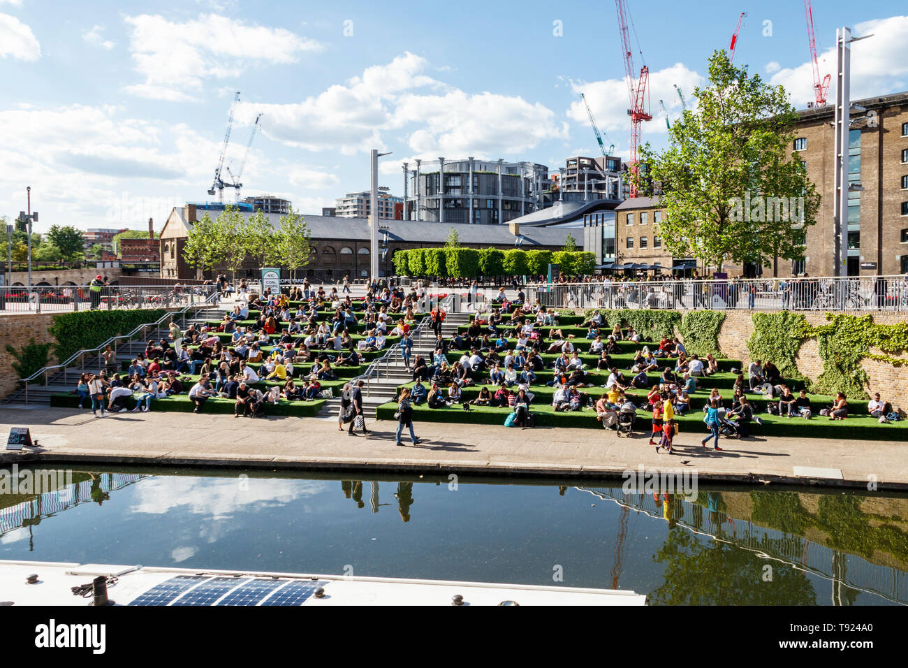 Londoners basking in spring sunshine on the steps of Granary Square by ...