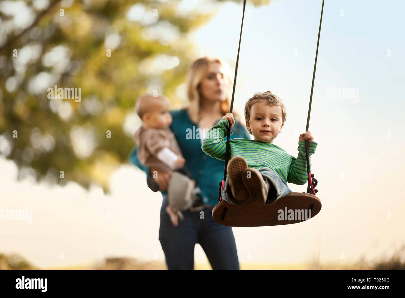Child pushed on swing hi-res stock photography and images - Alamy