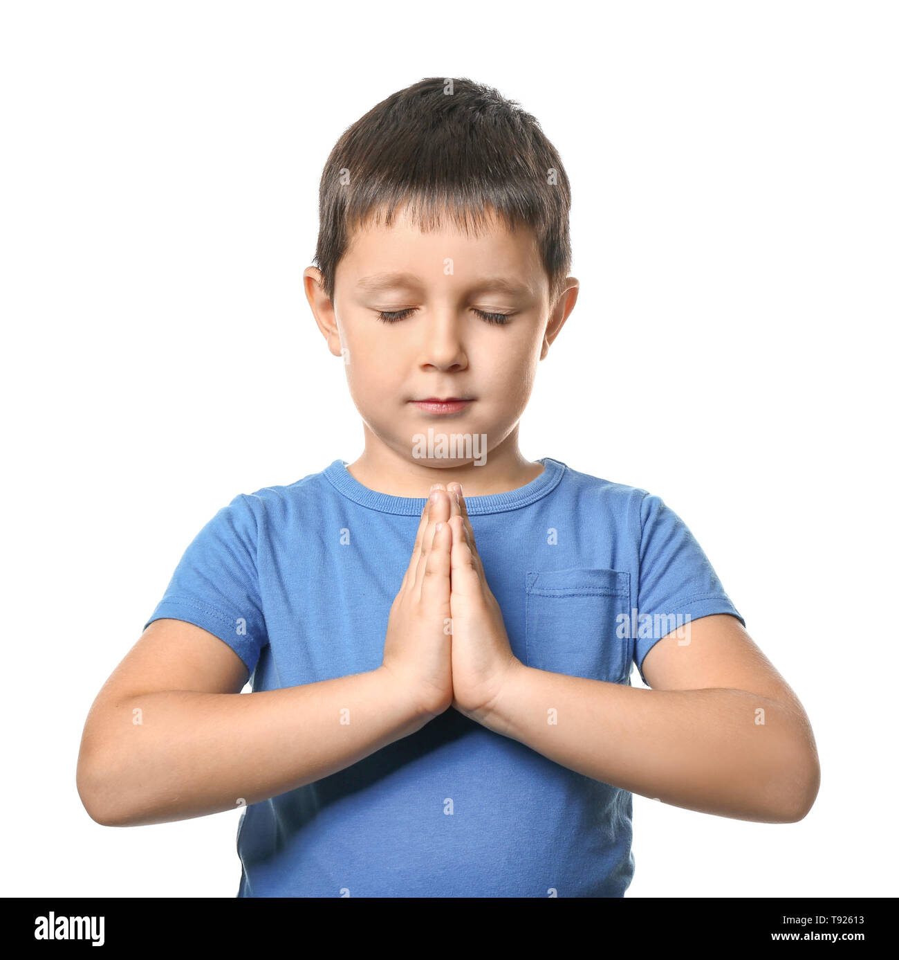 Little boy praying on white background Stock Photo - Alamy