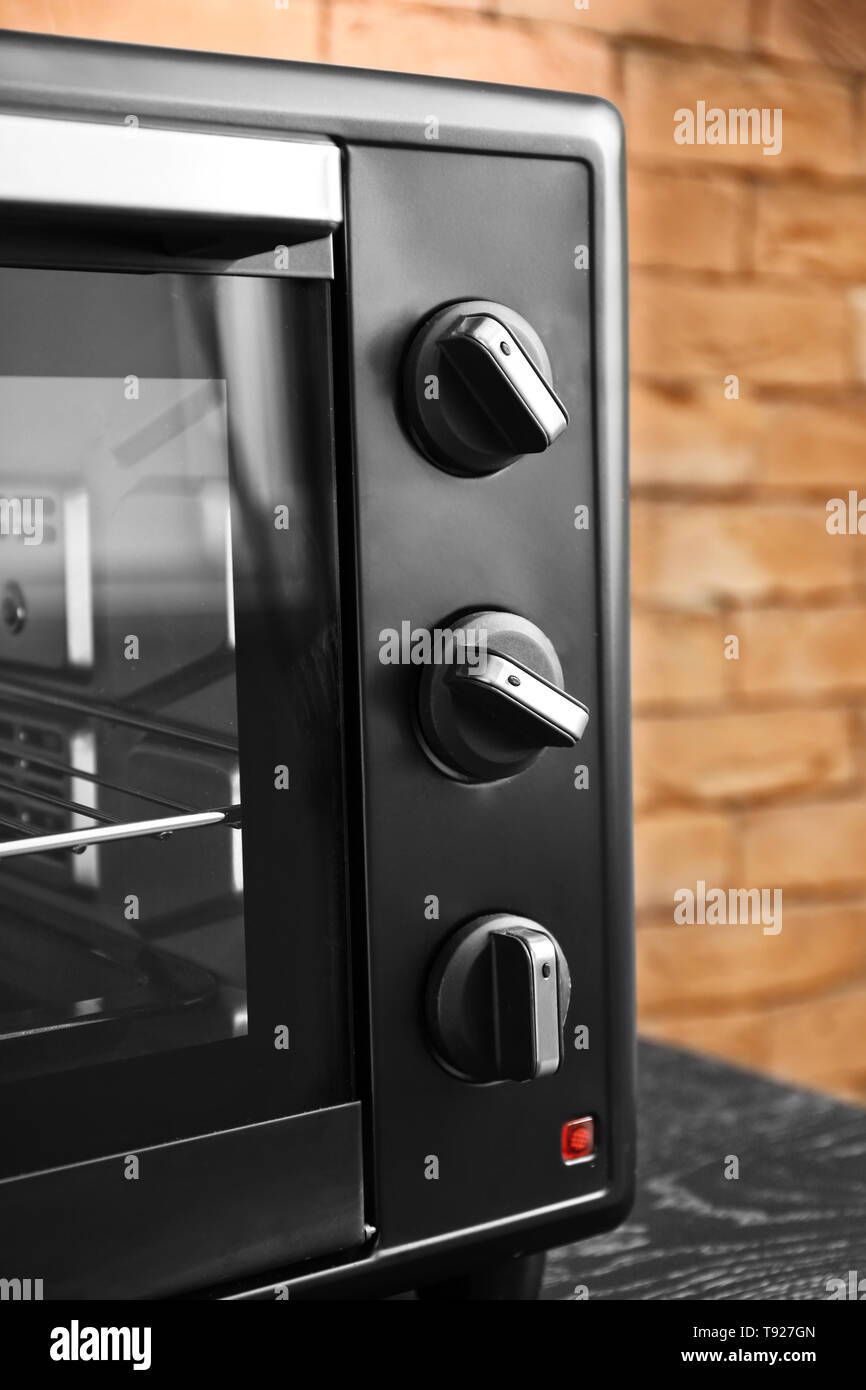 Modern electric oven on dark table, closeup Stock Photo - Alamy